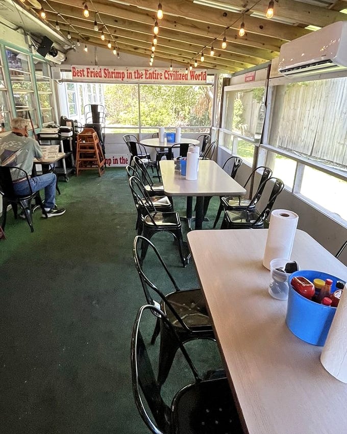 Simple metal chairs, screened windows, and that banner proclaiming seafood supremacy—this isn't about the décor, folks. It's about what's coming to your table.
