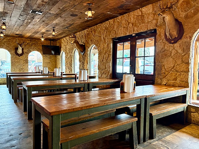 Rustic stone walls and wooden tables create the perfect backdrop for serious barbecue business. Those mounted trophies have witnessed countless "first bite" food epiphanies.