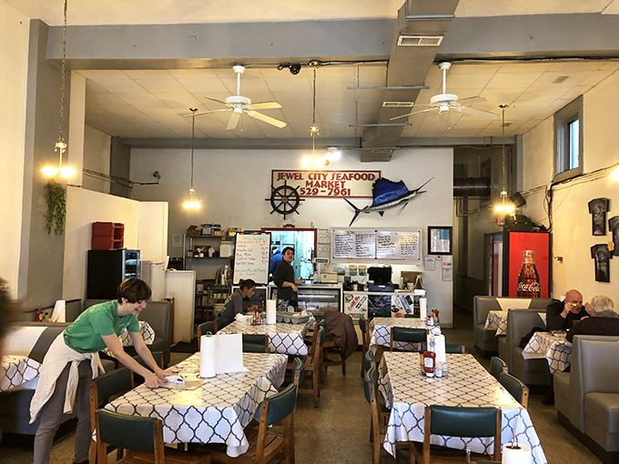 Simple tables, nautical accents, and ceiling fans create that perfect "focus-on-the-food" atmosphere where memorable meals happen without pretension.