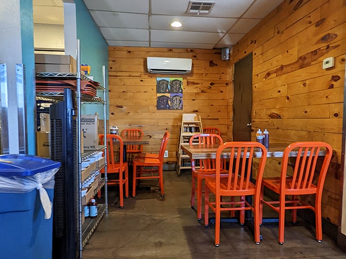 Orange chairs pop against rustic wood walls&mdash;minimalist decor that whispers, "We're too busy perfecting meat to fuss with fancy furnishings.
