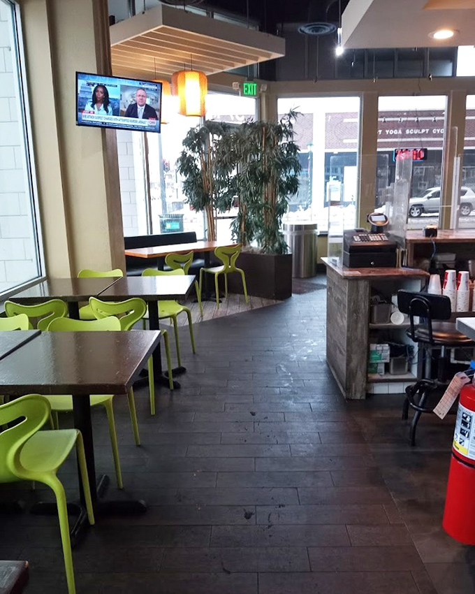 Modern minimalism meets comfort food haven. Those lime green chairs aren't just a design choice&mdash;they're your invitation to sit and stay awhile.