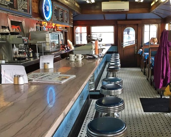 Step inside and travel back to simpler times. The counter beckons with its row of gleaming stools, each one a front-row seat to breakfast theater.
