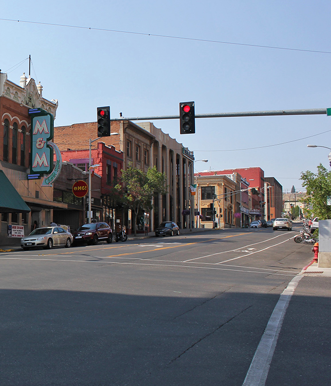 The M&M sign beckons from downtown Butte, where streets named after minerals lead to authentic local businesses rather than tourist traps designed to empty your wallet.
