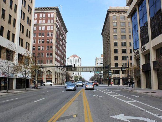 Downtown Wichita's historic buildings stand like sentinels of another era, connected by a skybridge that whispers tales of the city's storied past.