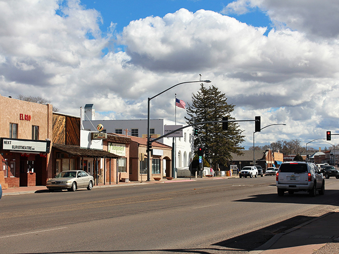 American flags and blue skies frame Springerville's downtown, where every building tells a story and nobody's in a hurry to finish telling it.