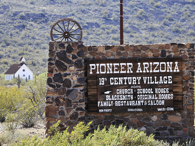 This stone entrance sign isn't just marking territory&mdash;it's a portal to the 1800s. The wagon wheel perched atop says, "Leave your Instagram expectations at the gate."