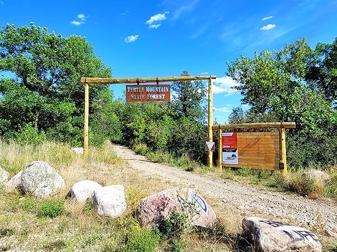 The rustic entrance sign welcomes adventurers with understated charm. No flashing neon here&mdash;just wood, sky, and the promise of wilderness ahead.