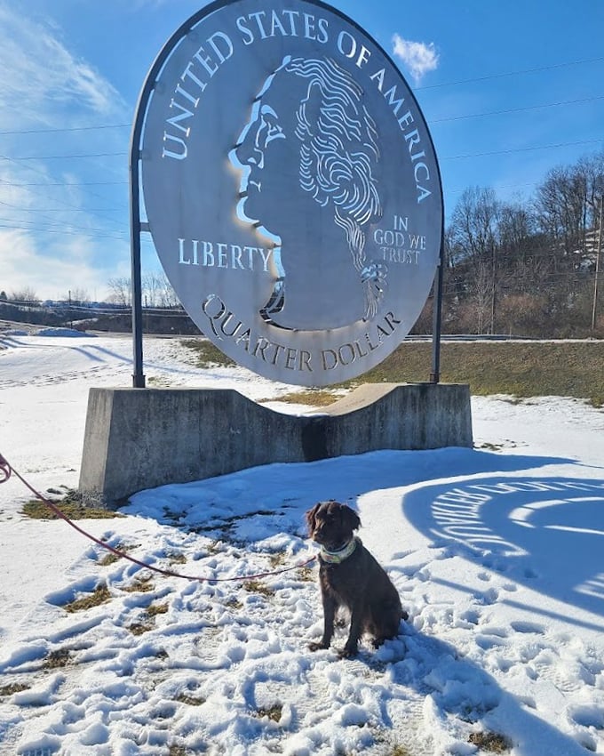 Winter transforms the Giant Quarter into a snow-dusted monument where even four-legged friends appreciate the value of roadside Americana.