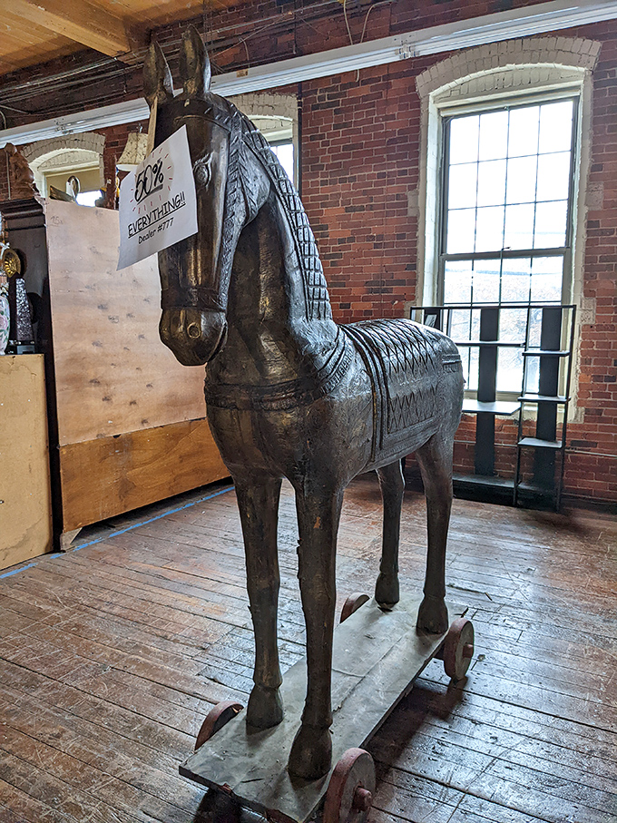 "60% off everything!" declares the sign on this magnificent wooden horse. At that price, you might need to build a bigger living room.