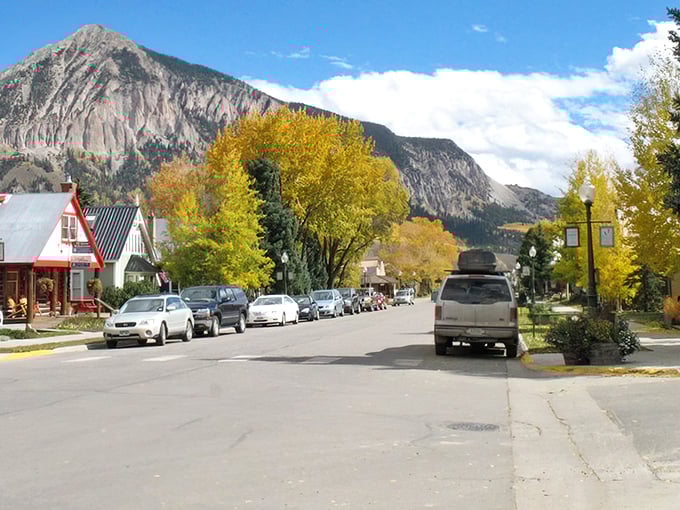 Autumn's golden touch transforms this mountain street into nature's own masterpiece of color and light.