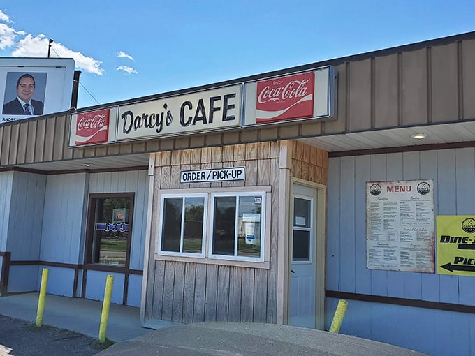 Darcy's Cafe, flanked by classic Coca-Cola signs, looks like the kind of place where the coffee's strong and the gossip's stronger.