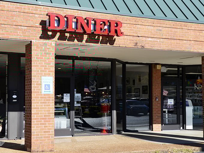 Simple red letters spelling "DINER" against brick—sometimes the best food hides behind the most straightforward advertising.