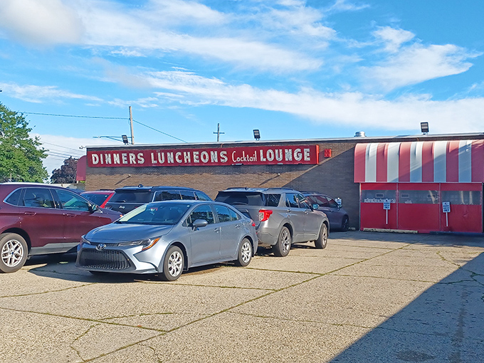Red and white stripes that say "serious pizza happens here." This place has probably seen more family celebrations than a Hallmark movie marathon.