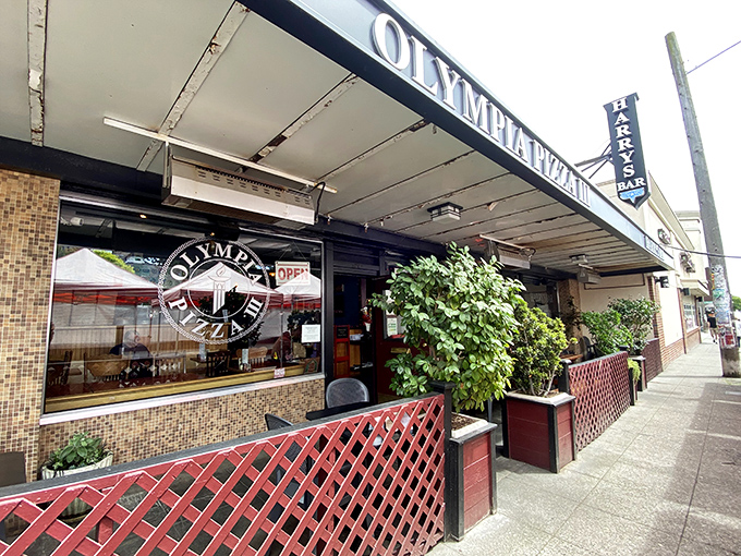 Olympia Pizza's classic storefront with its red lattice fence feels like that Italian restaurant from every great 90s sitcom.