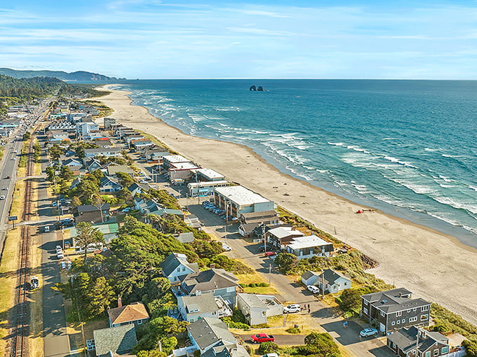 Rockaway Beach's endless shoreline beckons with affordable beachfront living and Twin Rocks standing guard offshore.