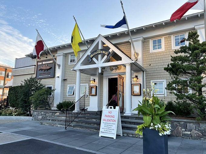 The Mooring's nautical elegance stands proud with colorful flags waving, like a delicious embassy of seafood diplomacy in Newport Harbor.
