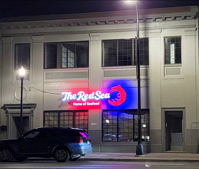 The Red Sea's glowing sign is like a lighthouse for seafood lovers. That neon lobster practically beckons you inside!