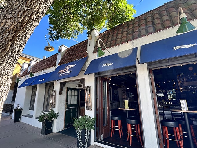 Blue awnings and Spanish architecture make Max Gill & Grill feel like a coastal escape in the heart of Denver.