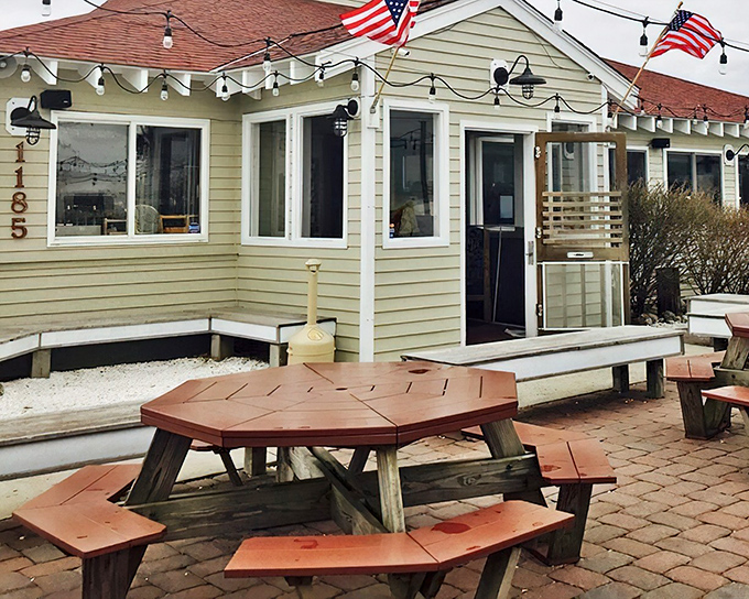 The weathered shingles and American flags aren't just decoration&mdash;they're Mud City's promise that authentic shore dining awaits inside.
