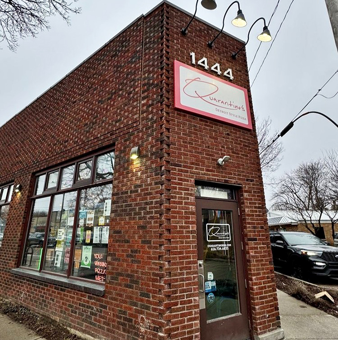 That understated sign belies the flavor explosion waiting inside this Grand Rapids gem. Detroit-style pizza never looked so promising.