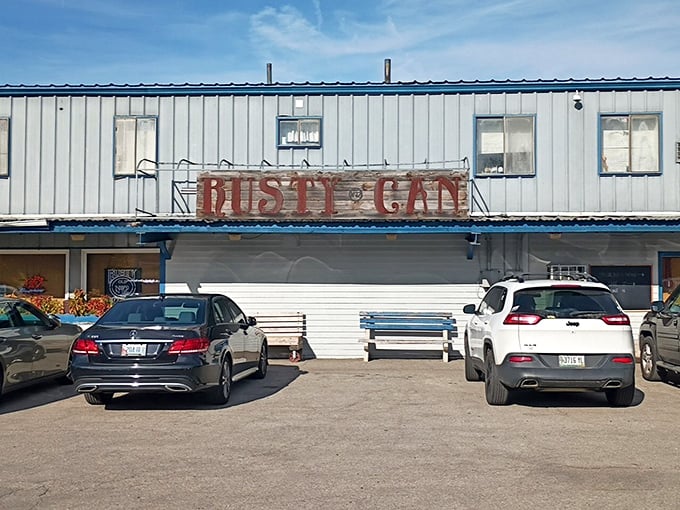 Rusty Can parking lot: Cars line up like eager contestants at this unassuming BBQ joint - they know the real winners get their ribs early.