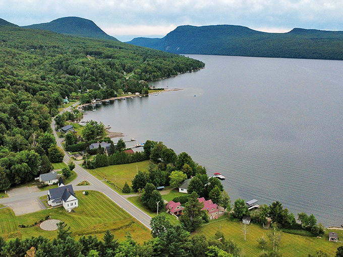 Westmore's shoreline curves gently along Lake Willoughby, where mountains stand guard like ancient sentinels watching over swimmers.