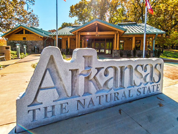 The Arkansas Welcome Center stands as a rustic gateway to the Natural State, where retirement dollars find their supernatural stretching abilities.