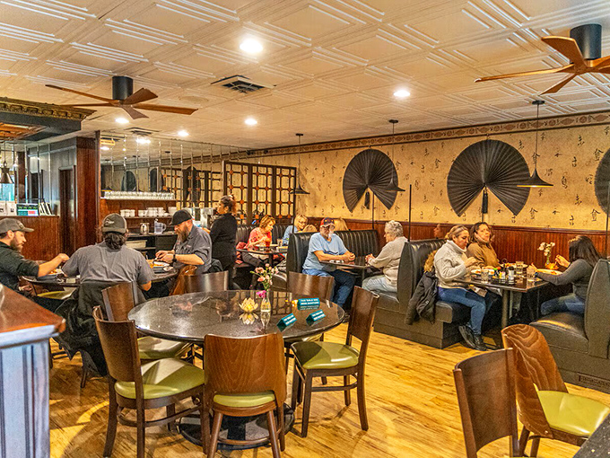 Where locals gather for good conversation and better food. The warm wood paneling and fan-adorned walls create an atmosphere as inviting as the menu.