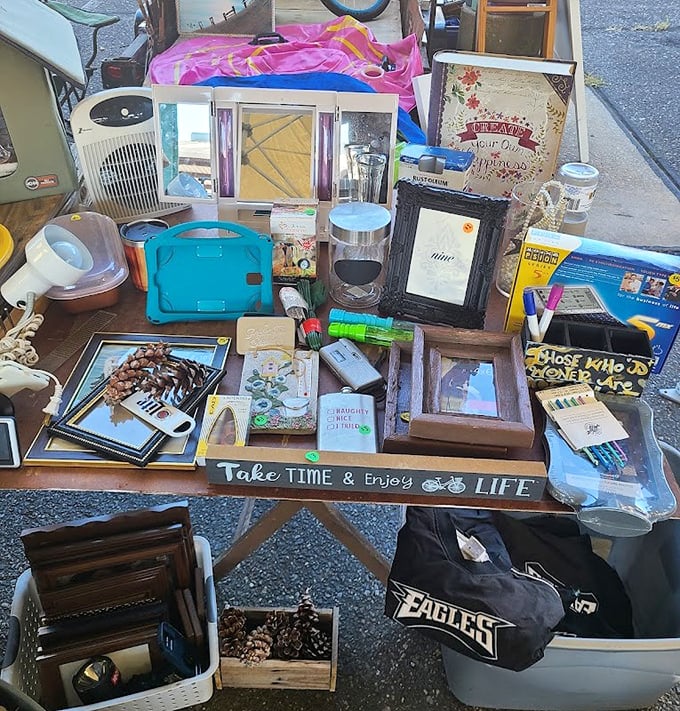 One person's "I don't need this anymore" is another's "I've been looking everywhere!" This table's jumble of frames and knickknacks tells a thousand stories.