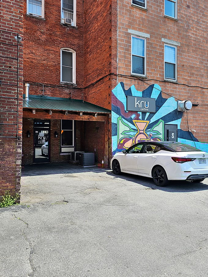 Kru Coffee's vibrant mural announces itself like a caffeinated beacon, promising artisanal brews without the Manhattan price tag or attitude.