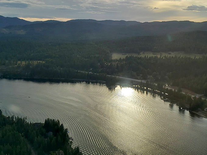 Golden hour transforms Lake Pend Oreille into a shimmering mirror reflecting the surrounding mountains. When nature turns the dimmer switch, magic happens.