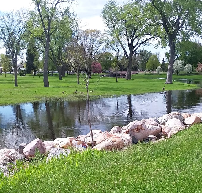 McKinley Park's serene waters reflect towering trees like nature's own Instagram filter, creating a peaceful retreat that costs absolutely nothing to enjoy.