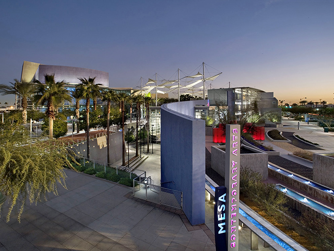 The Mesa Arts Center's striking modern architecture serves as the cultural heartbeat of the city, illuminated beautifully against the twilight sky.