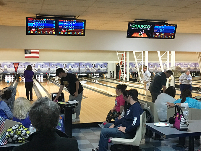 At Claremont's bowling alley, generations gather for friendly competition where the sound of striking pins provides the soundtrack to community connections.