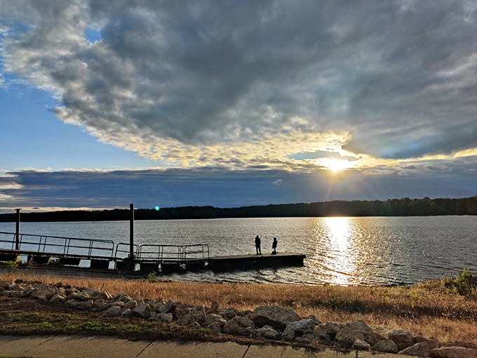 Golden hour magic transforms the Mississippi into liquid amber. Two silhouettes on the dock remind us that some moments are best shared in reverent silence.