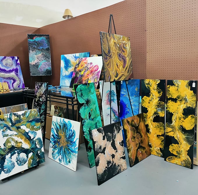 A kaleidoscope of artistic expression lines the walls, each canvas telling a different story through vibrant swirls and bold splashes.