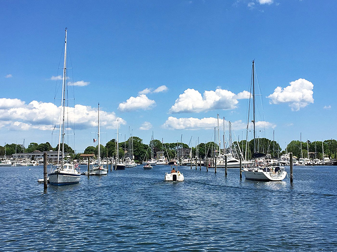 Sailboats bob gently in Wickford Harbor under cotton candy clouds &ndash; nature's way of saying "put down your phone and look at this instead."