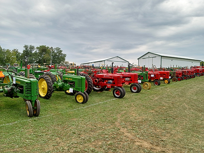 A rainbow of agricultural history! John Deere green meets International Harvester red in this impressive display of vintage tractors that built America.