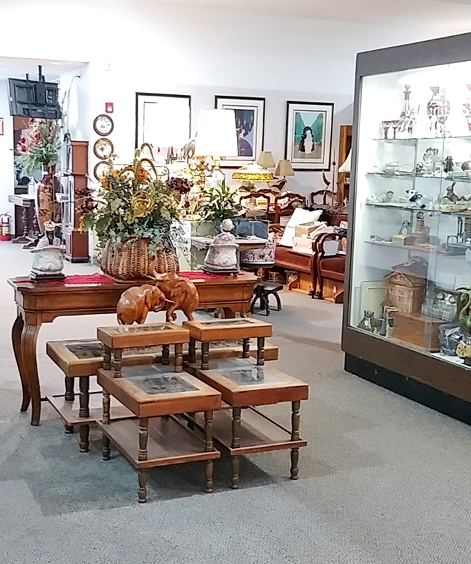 Elegant wooden nesting tables and carved figurines await new homes. That elephant has seen more history than most history books.