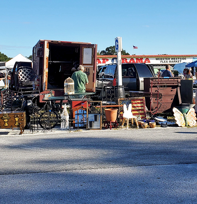 Treasure hunting at its finest! A vendor's eclectic display showcases everything from wrought iron garden pieces to vintage furniture, all waiting for their second chance at love.