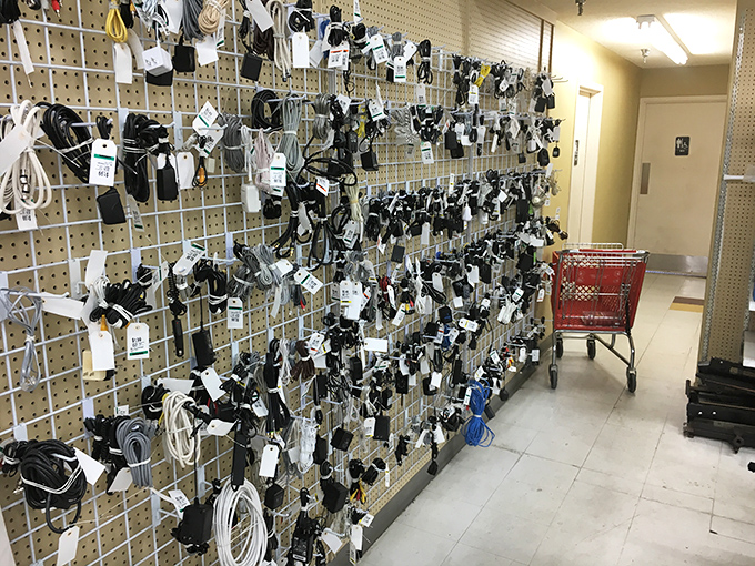 A wall of electronic accessories that would make any tech junkie swoon. One person's forgotten charger is another's power solution.