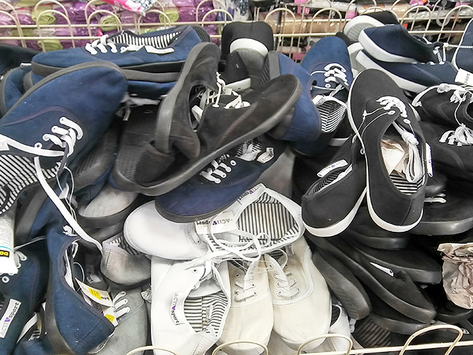 The footwear section resembles a sneaker convention where all the VIPs left their credit card limits at home. Somewhere in this pile is your next favorite pair.