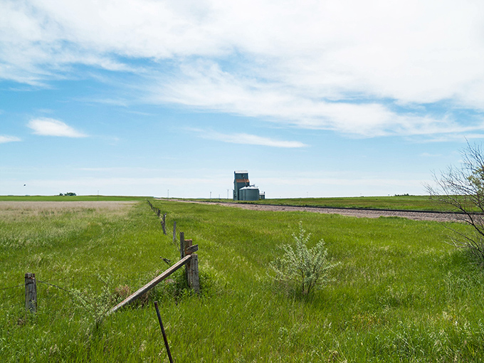In the distance, the grain elevator stands as a monument to agricultural dreams that once defined Griffin's existence.