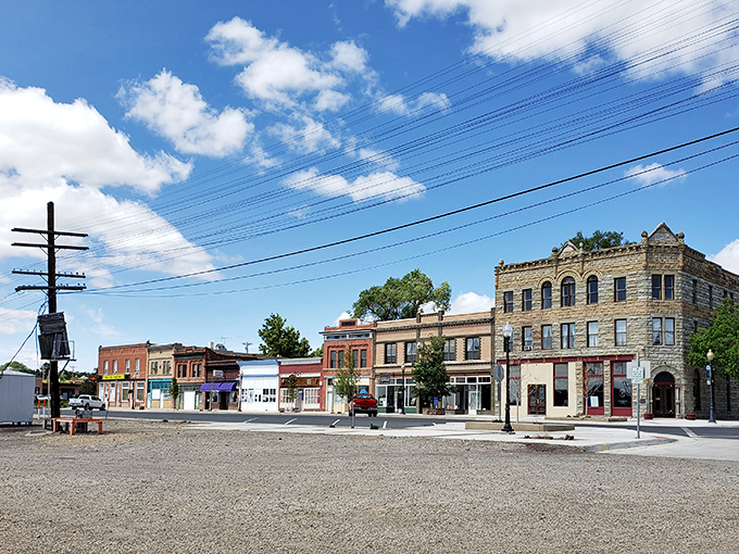 Raton's historic buildings line the street like a welcoming committee, their sandstone and brick facades telling stories of boom times and resilience.
