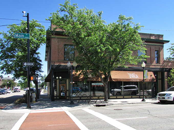 This brick building at Main Street's corner has witnessed more Littleton history than a courthouse bench, now housing shops where locals actually shop.