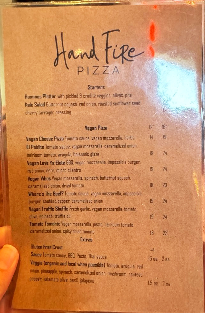 The vegan menu reads like a love letter to plant-based eaters - no sad salad afterthoughts here, just serious pizza artistry.