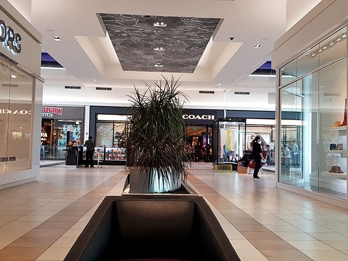 The pristine corridors invite you to stroll in climate-controlled comfort—no dodging raindrops or melting in summer heat between designer bargains.