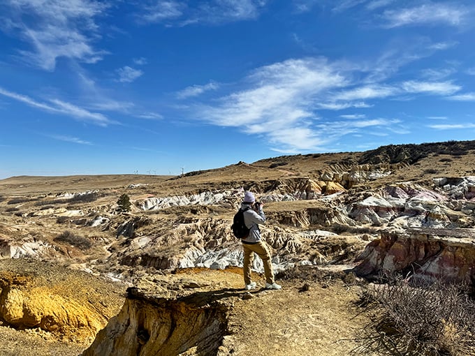 A solitary explorer gains perspective at the edge of this natural wonder, reminding us that sometimes the best views require standing on the precipice.