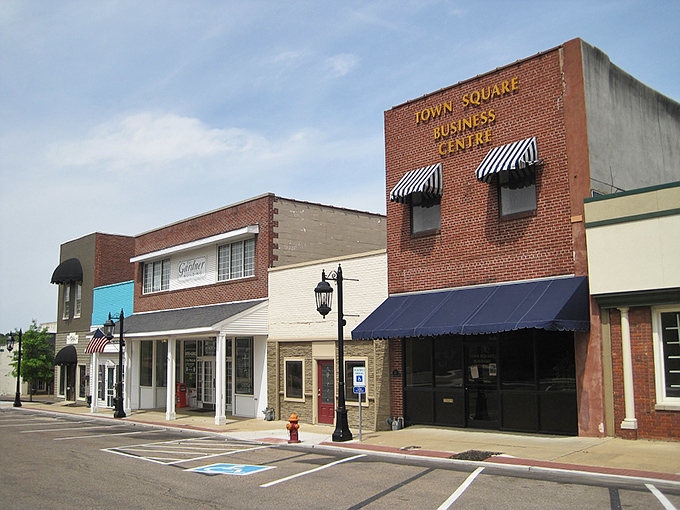 Brownsville's Town Square Business Centre offers small-town charm with classic brick architecture and striped awnings.