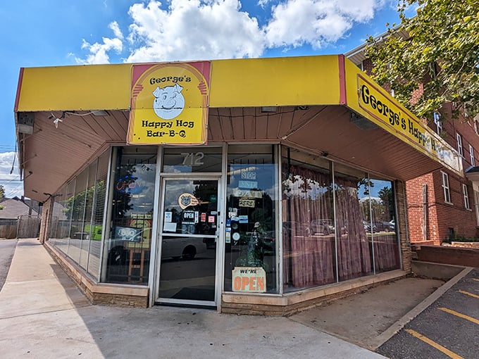 George's Happy Hog lives up to its name with that cheerful yellow storefront. The smiling pig logo knows exactly what you're in for!